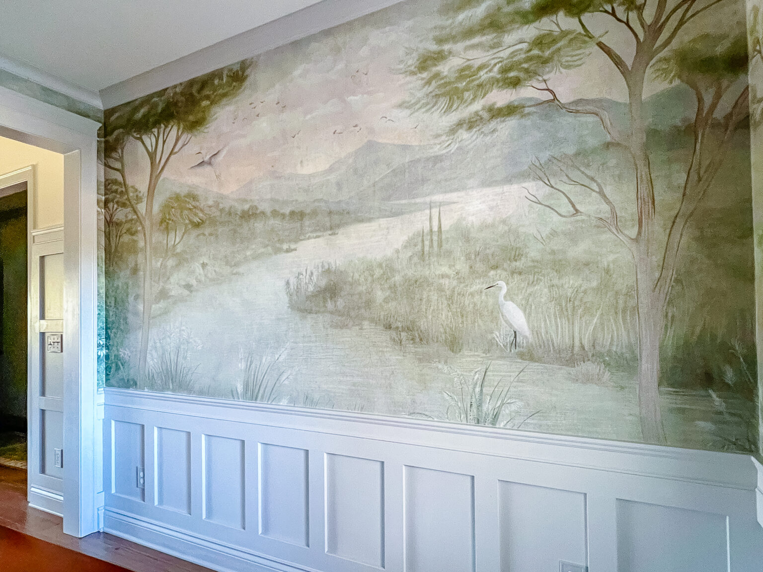 Pastoral Landscape Mural Envelops the Foyer - Deeply Southern Home